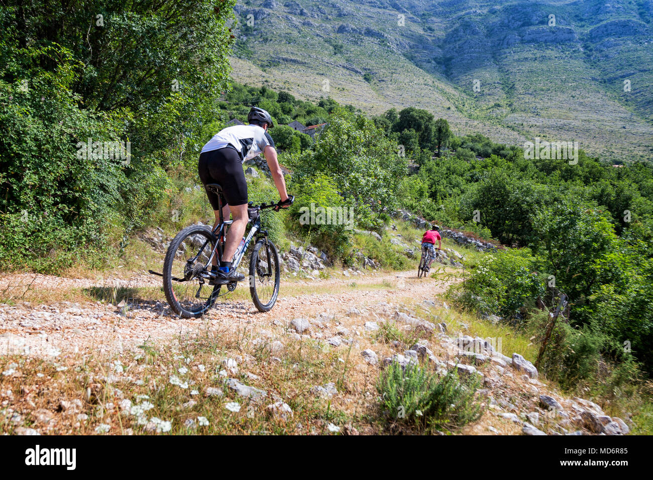 Two mountain bikers ride on a back-country road during Za Sirac Sira ...