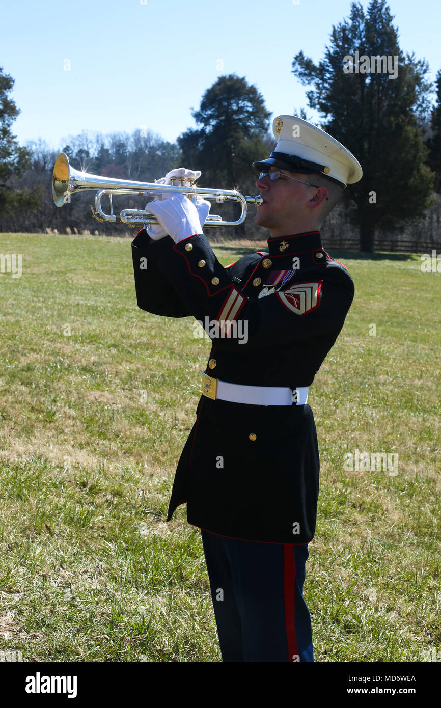 U.S. Marine Corps Staff Sgt. Kyle Schlick performs taps for the wreath ...