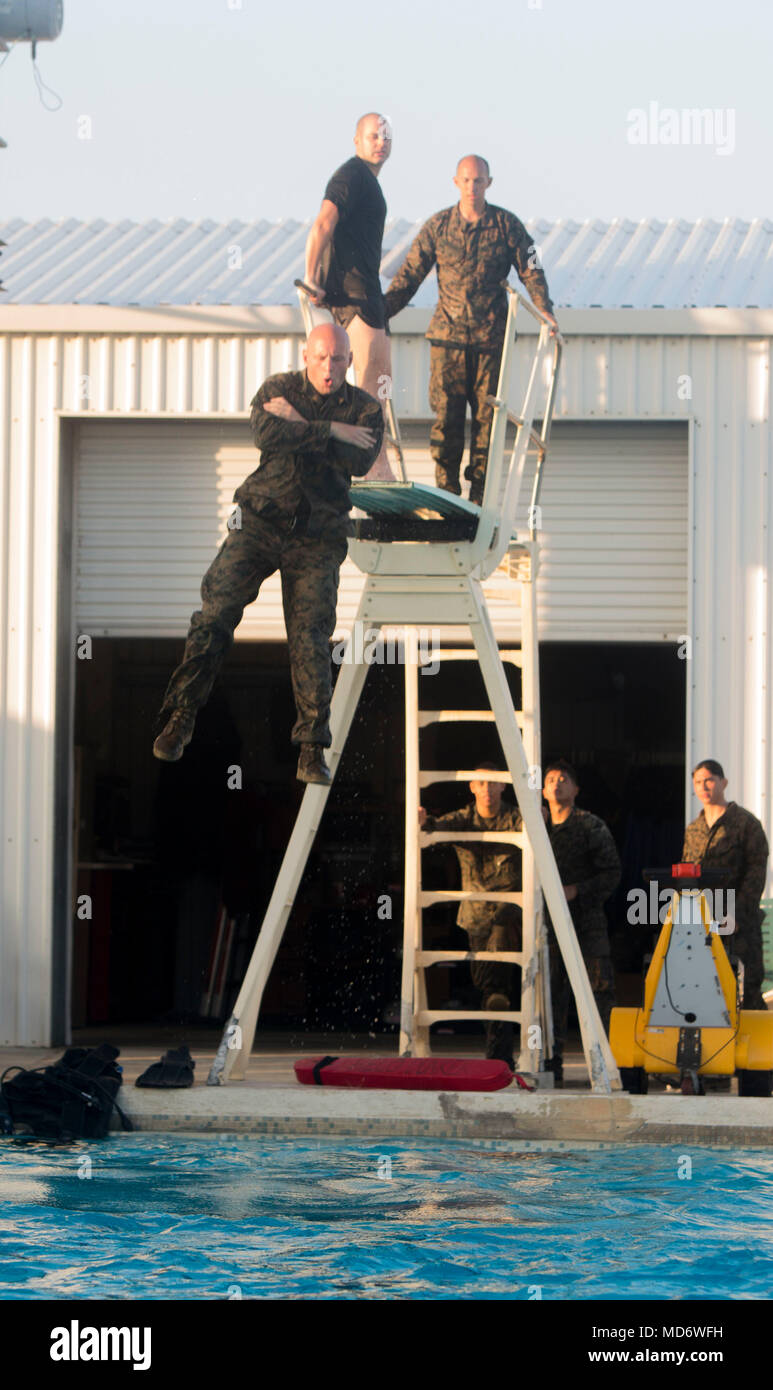 A U.S. Marine with 3rd Marine Regiment jumps off a diving board during ...