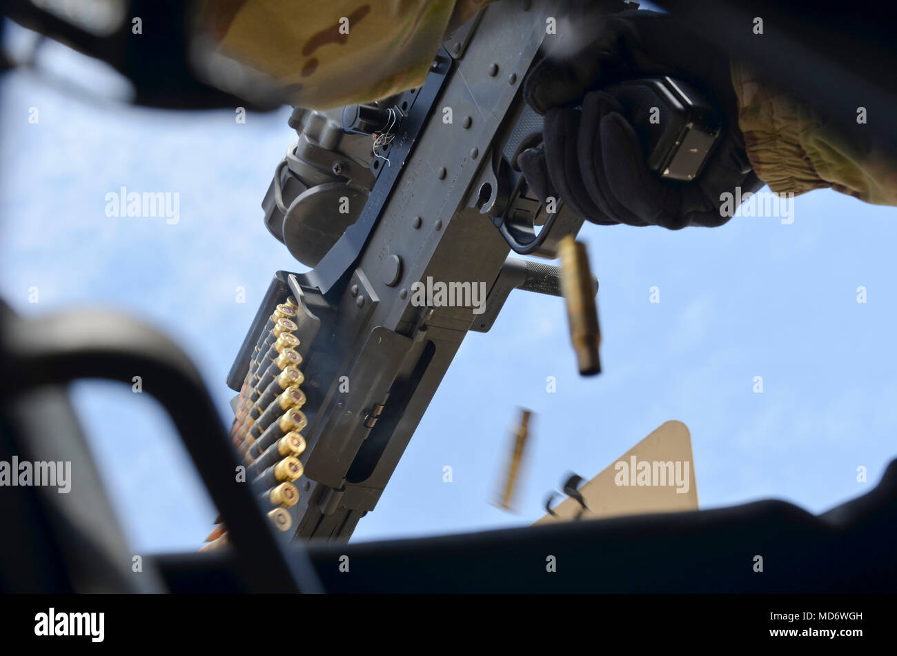 Ammunition brass is ejected from a M240B machine gun during convoy live ...