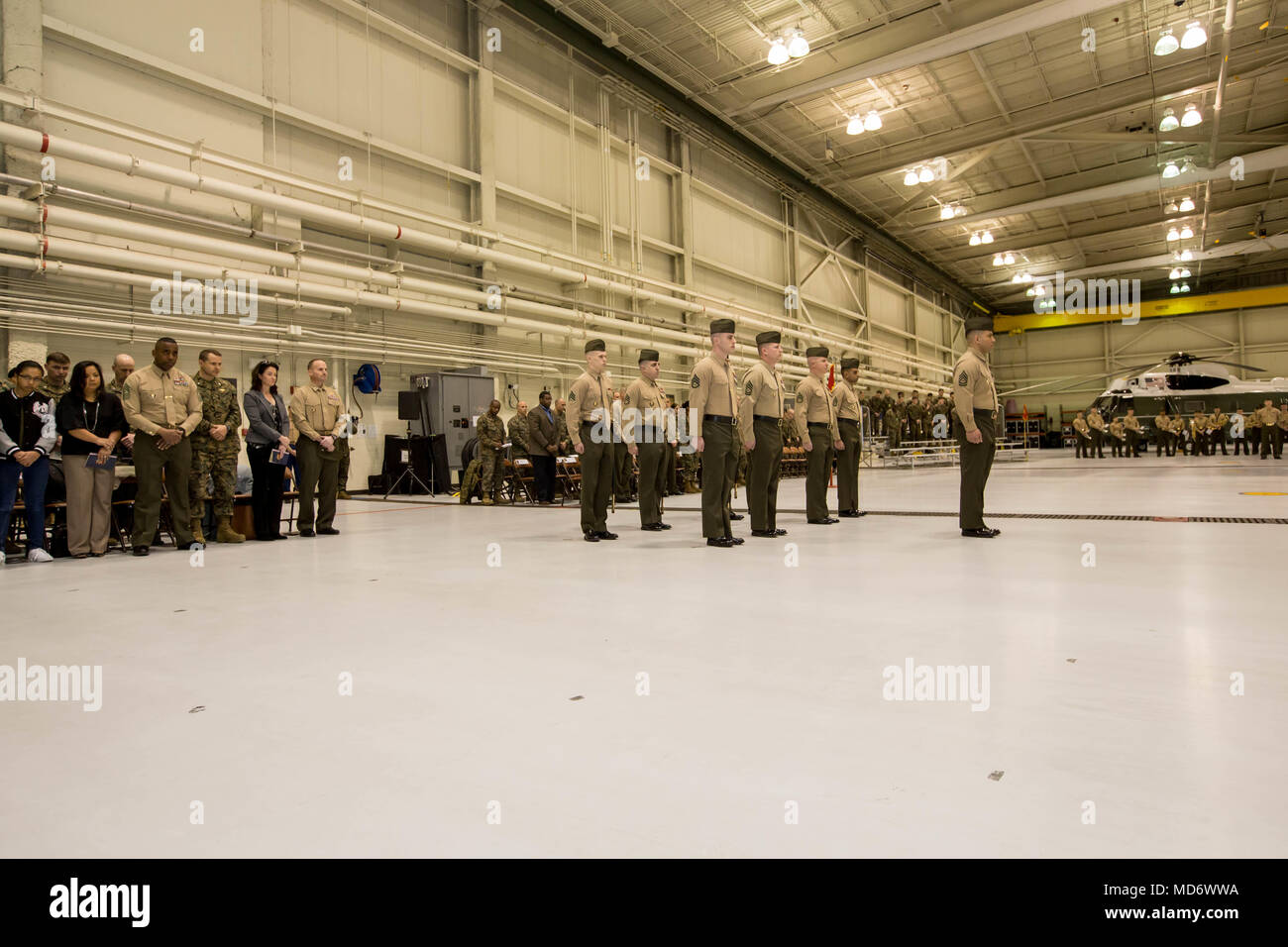 U.S. Marines and guests stand during an invocation at the Marine ...