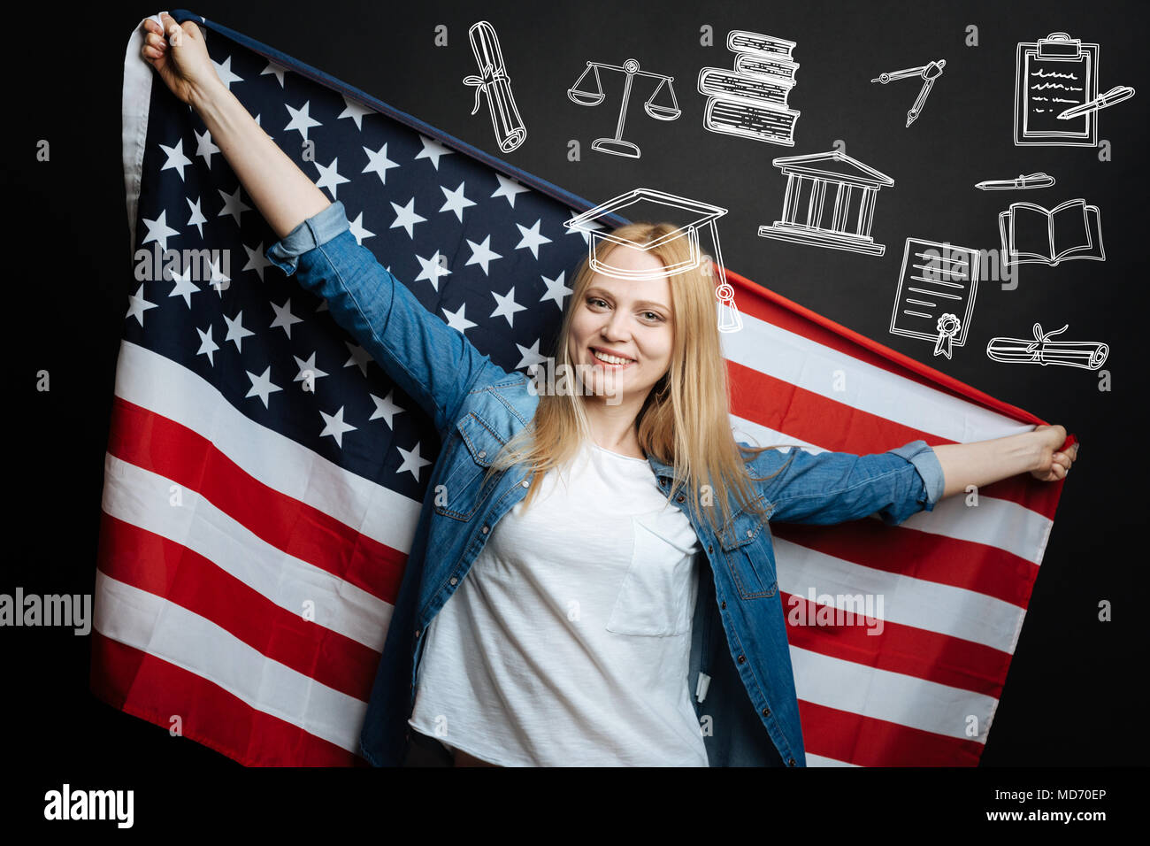 Patriotic woman smiling and holding a big flag of the USA Stock Photo ...