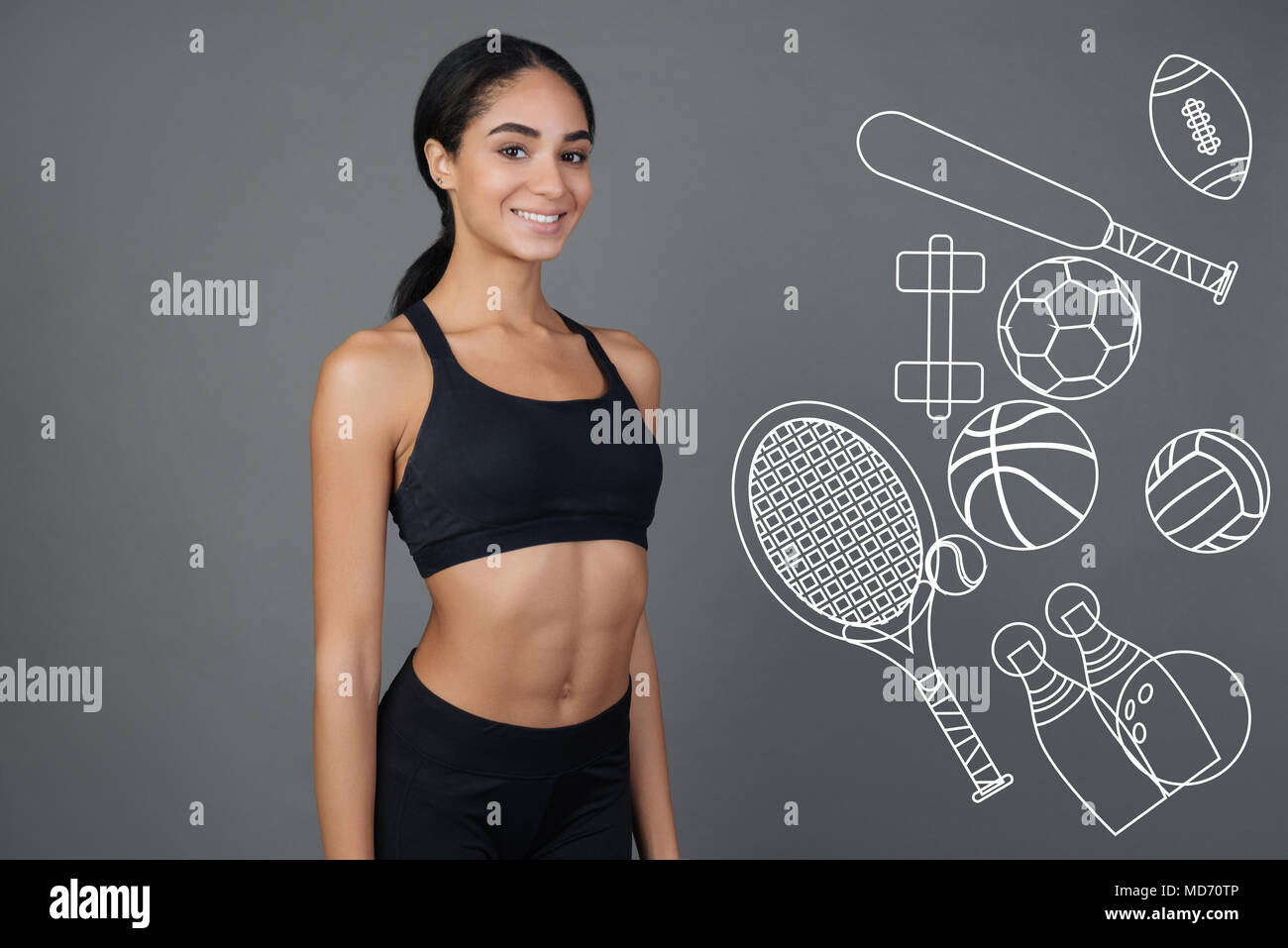 Active sportswoman smiling and thinking about her favorite team games ...