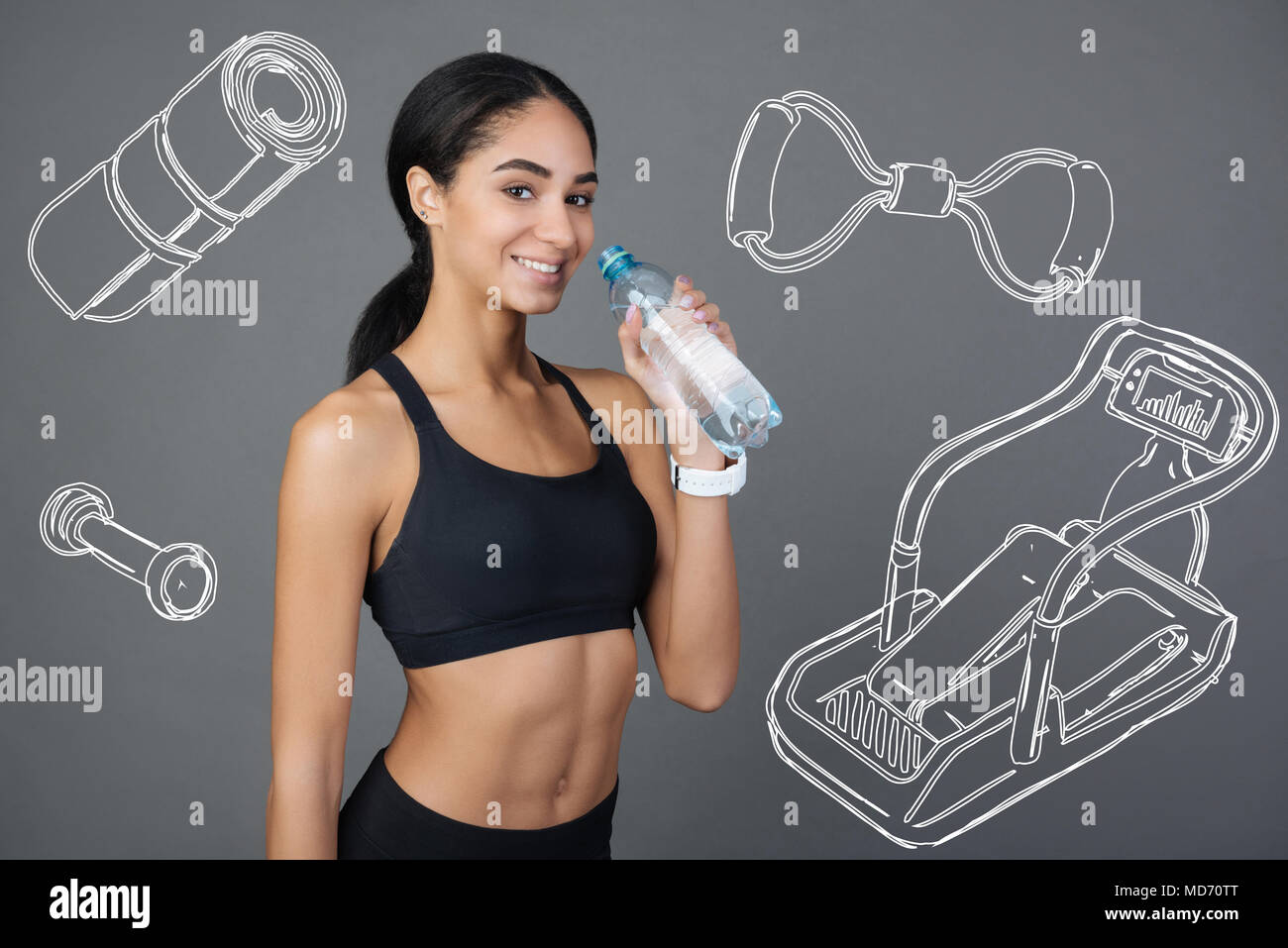 Active fitness trainer drinking water and smiling cheerfully Stock ...
