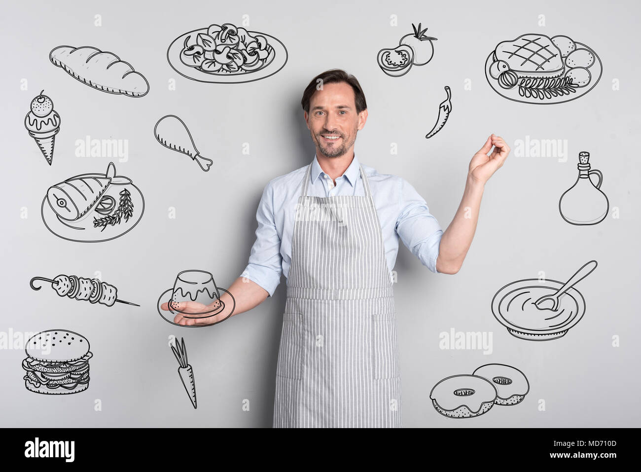Professional chef smiling while holding a tasty pudding Stock Photo - Alamy