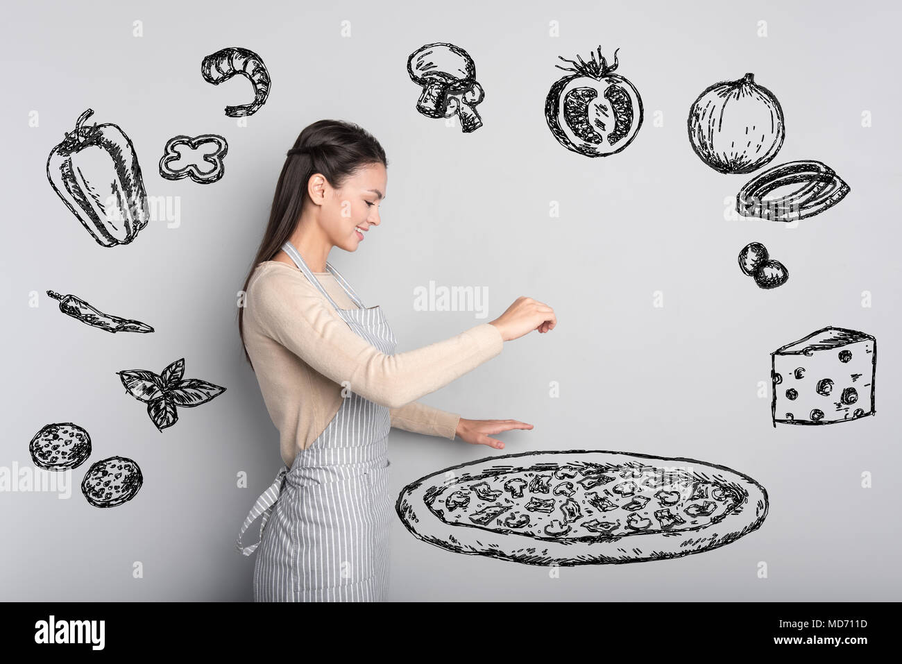 Positive student standing alone while cooking pizza Stock Photo - Alamy
