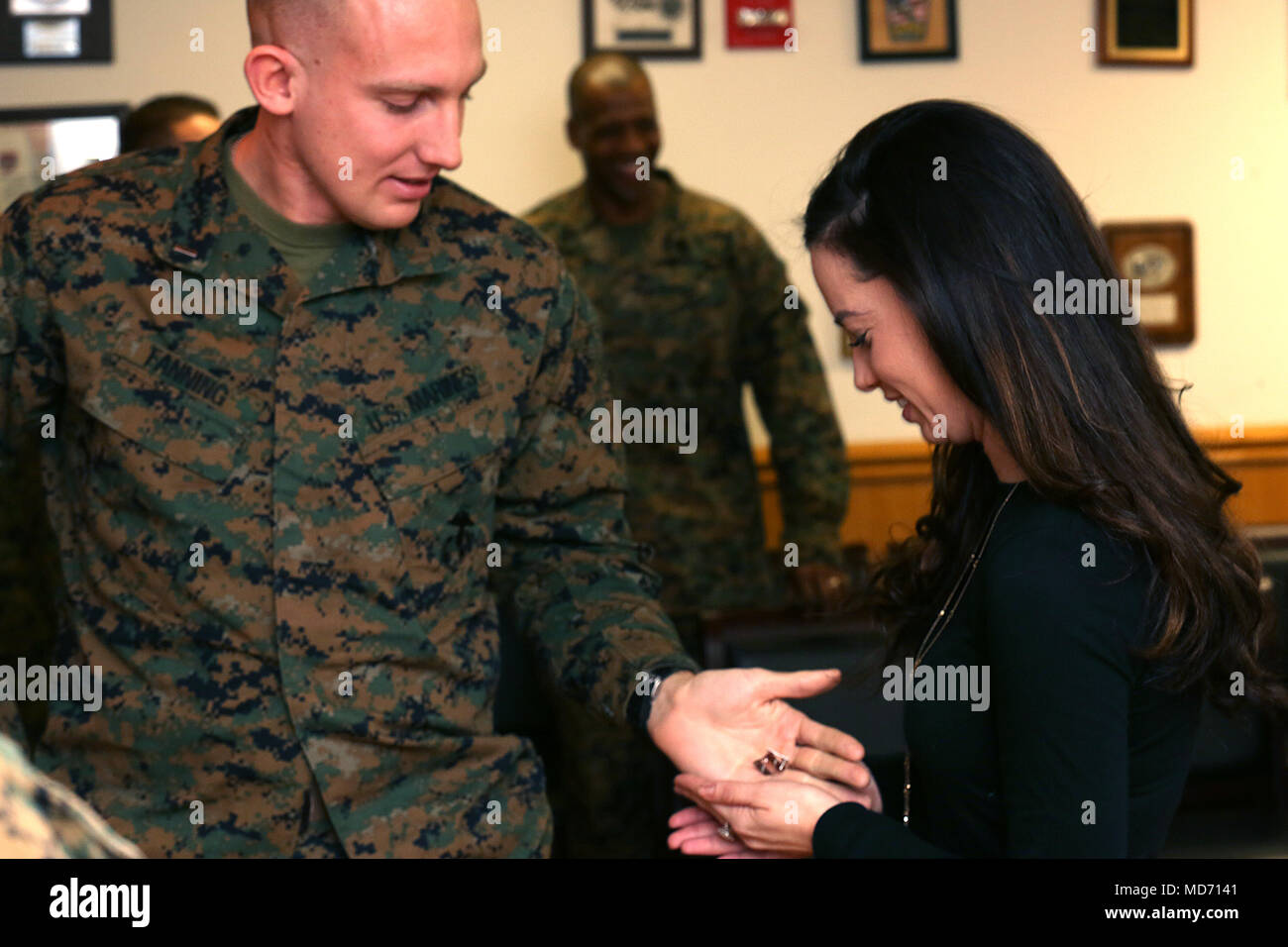 Houston, Texas-native Travis W. Fanning, left, hands a pair of captain ...
