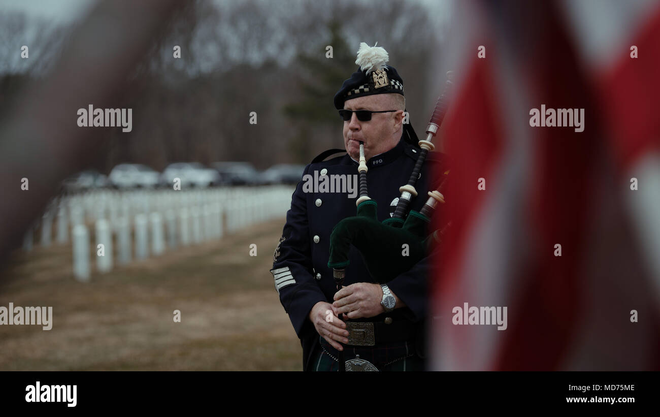 A bagpiper from the Eastern Long Island Police Pipes and Drums performs ...