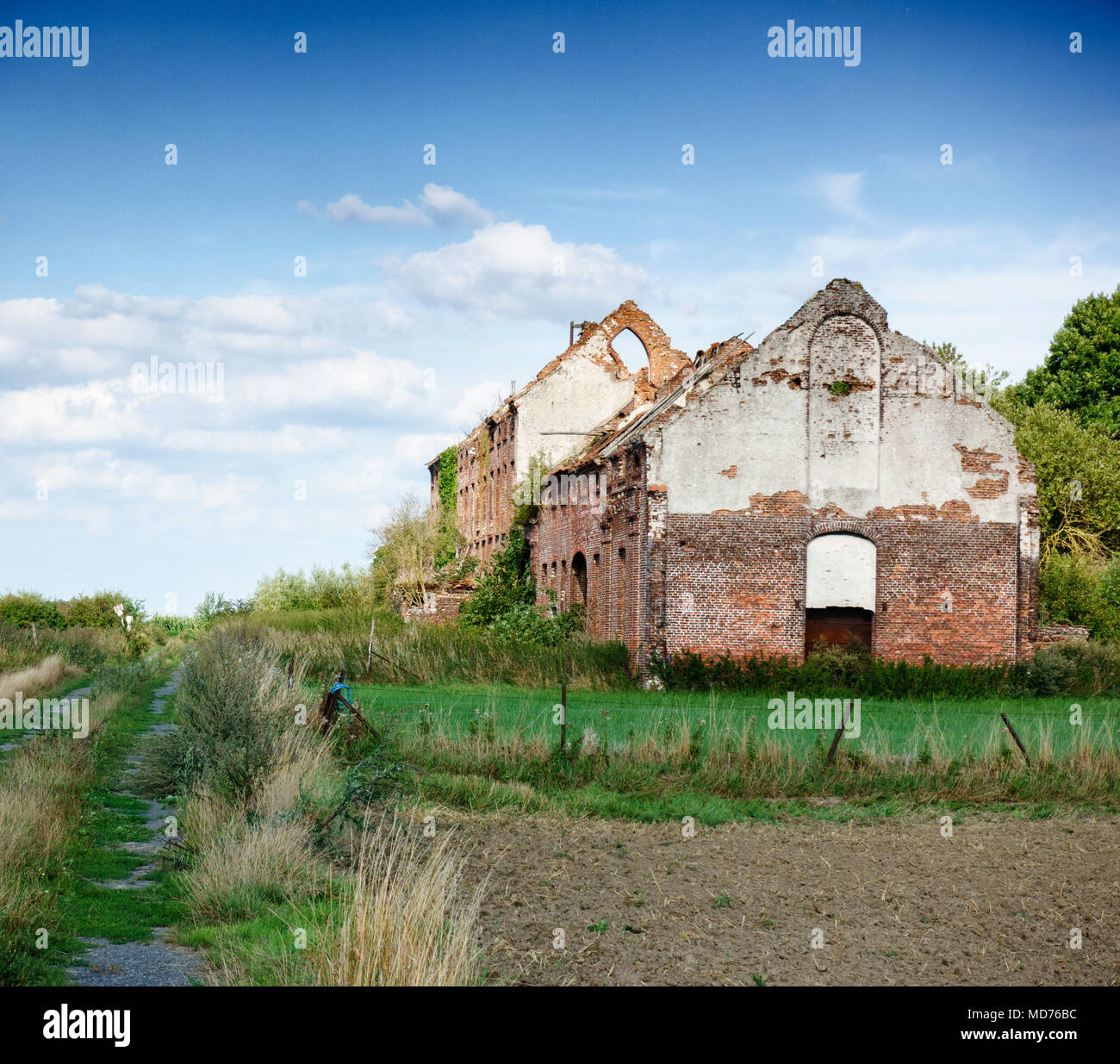 Abandoned ruins of brick structure and grass field Stock Photo - Alamy