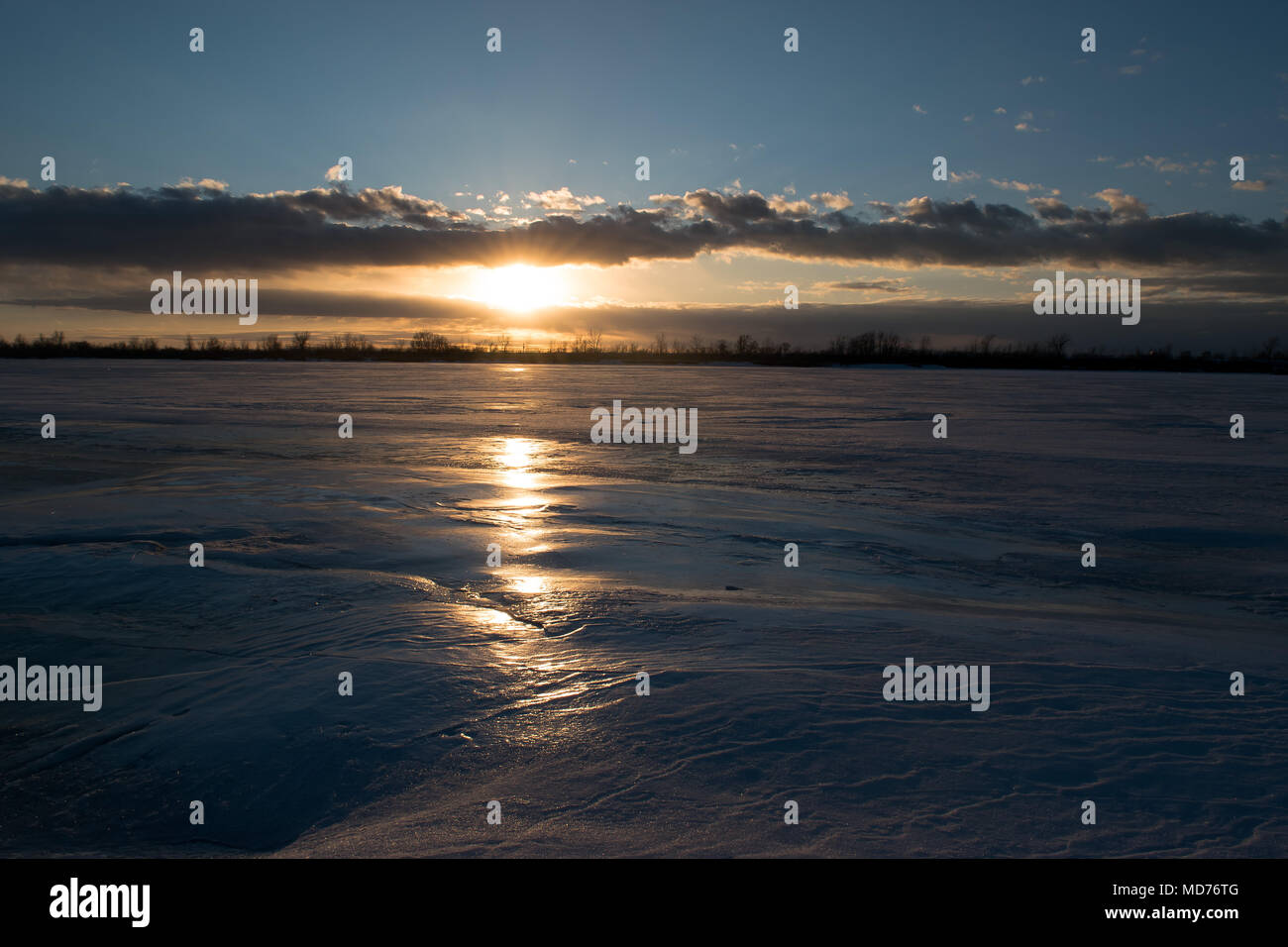Reflection of sun setting Stock Photo - Alamy