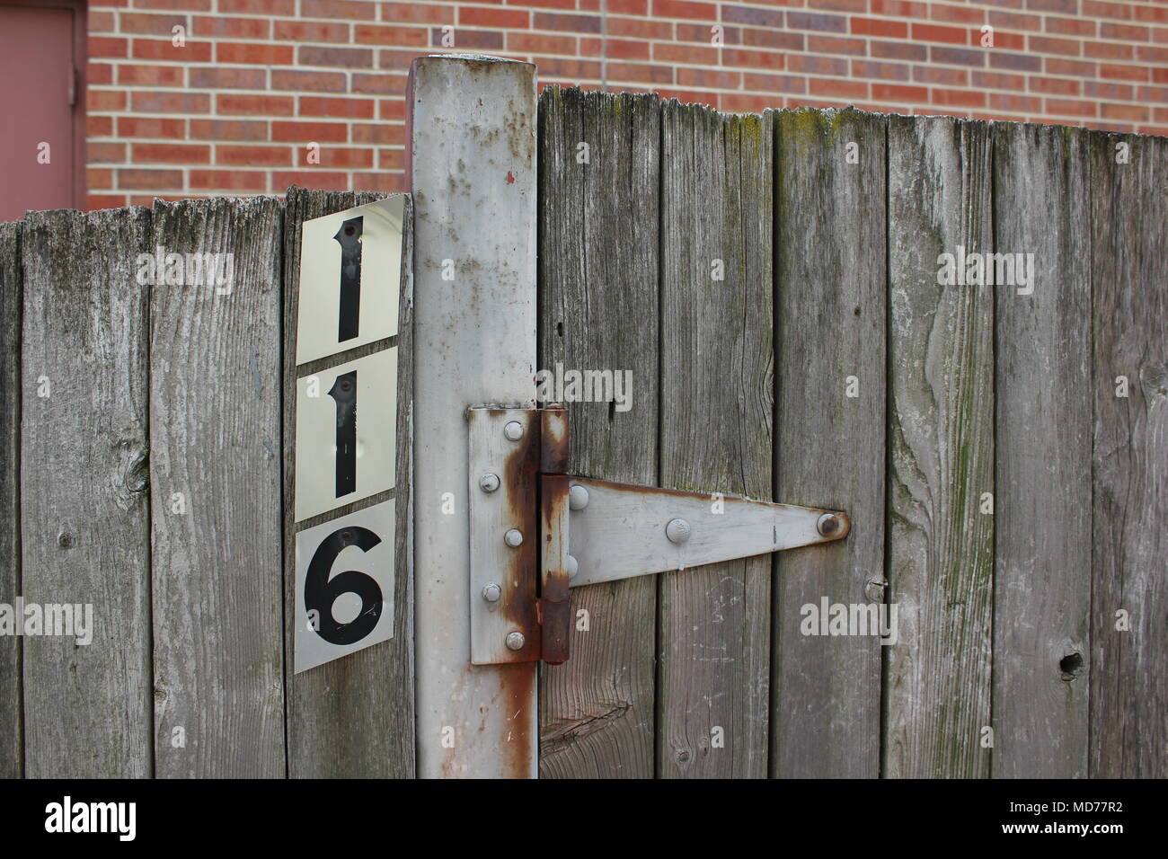 Massive wooden hinged gate with the number 116 placed on it Stock Photo ...