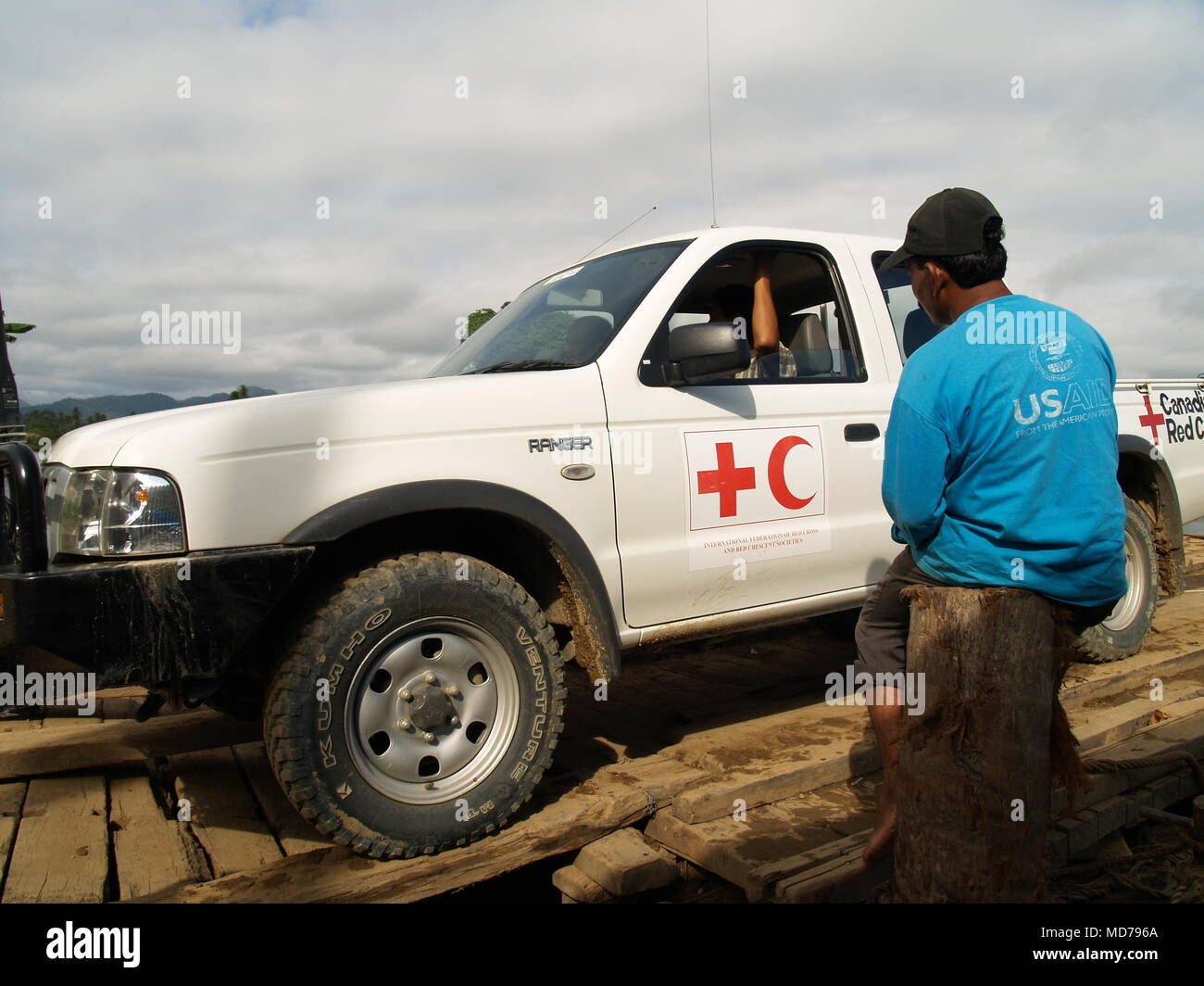 Red Cross Vehicle loaded on a raft to crossing over the water bay ...