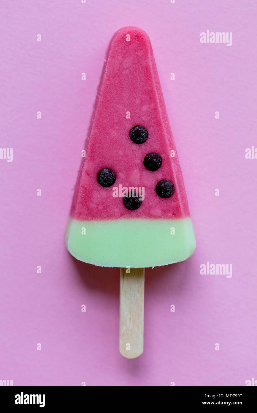 Watermelon shaped summer ice lolly on a pastel pink background Stock ...