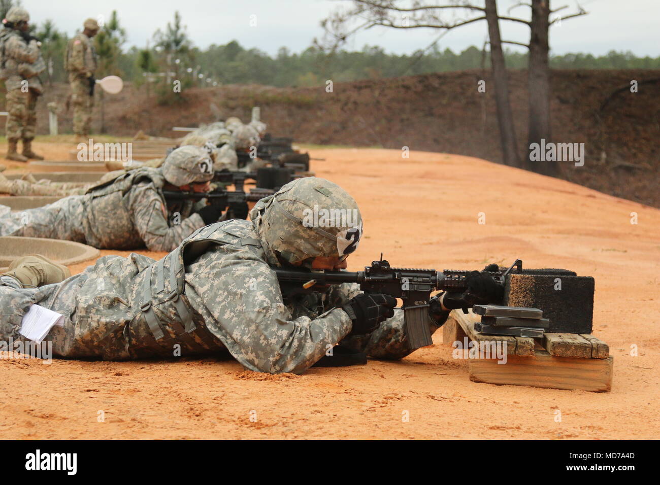 Soldiers in the medical career management field fire an M4 Carbine ...