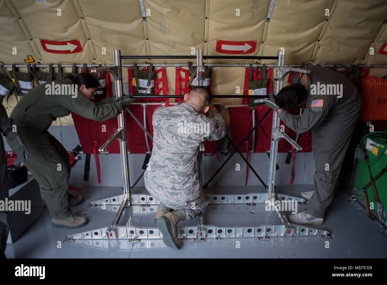 Aeromedical evacuation technicians assemble a stanchion litter system ...