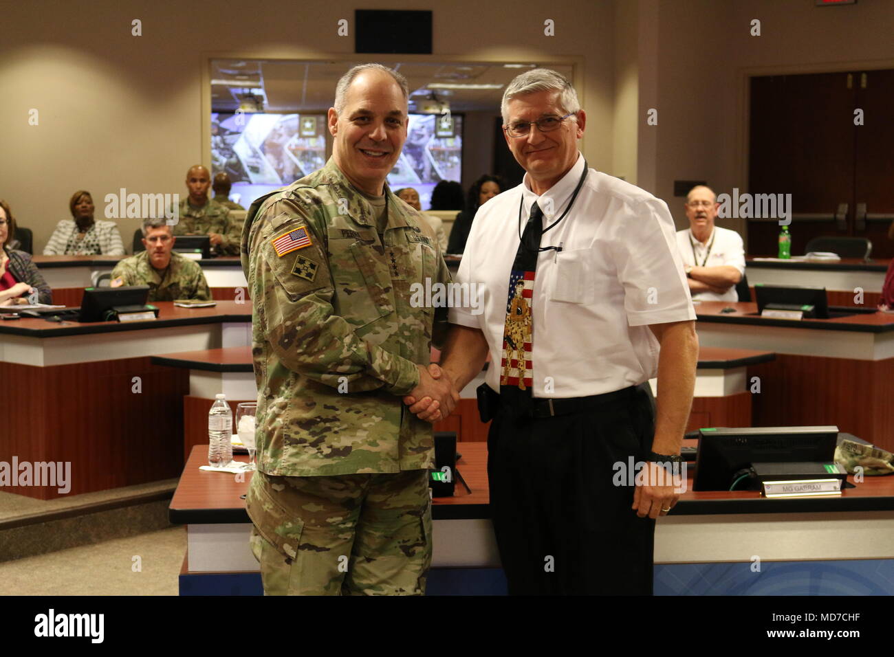 Army Materiel Command’s Commander Gen. Gus Perna presents a recognition ...