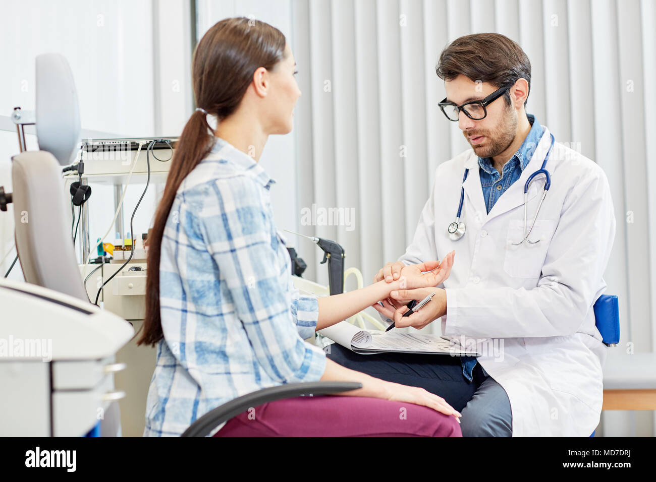 Doctor checking patient's pulse on the wrist at hospital Stock Photo ...