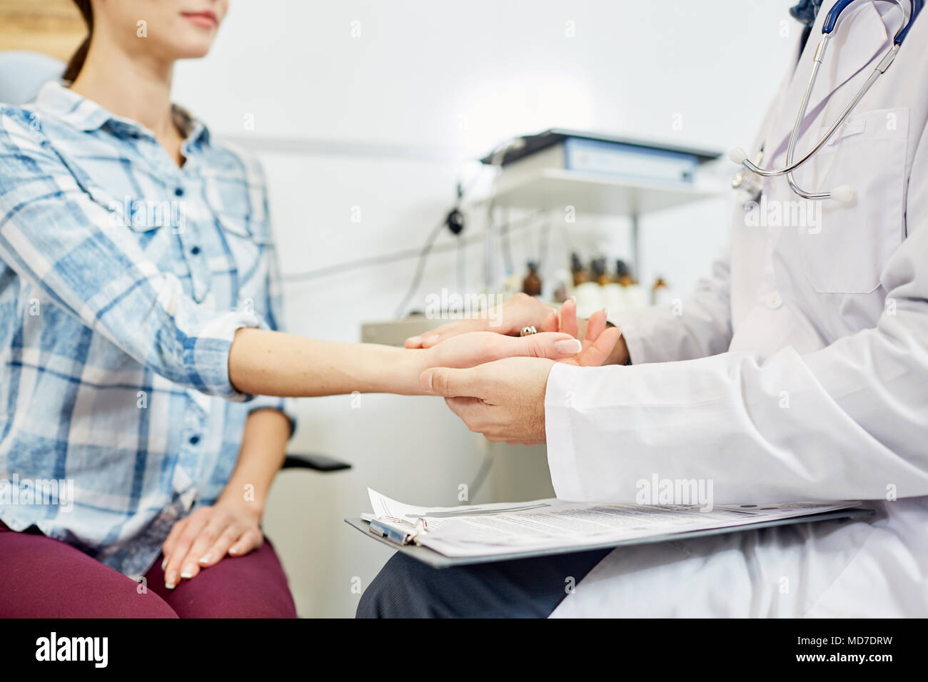 Doctor checking pulse hi-res stock photography and images - Alamy