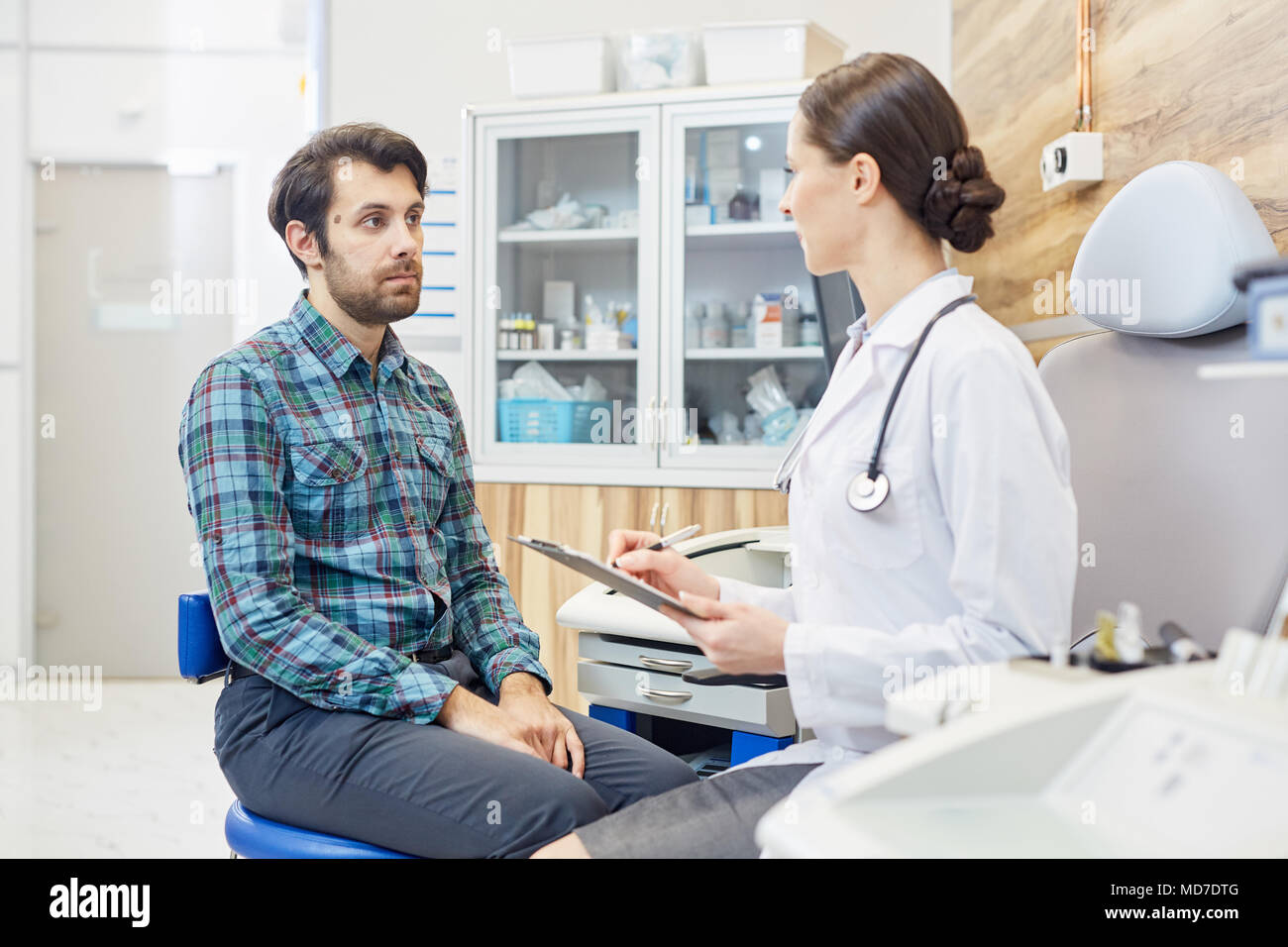 Male patient listening to the doctor at the hospital Stock Photo - Alamy