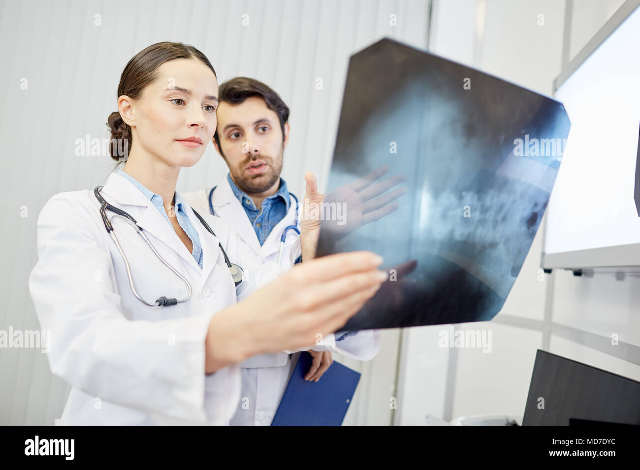 Team of surgeons examining x-ray image together Stock Photo - Alamy