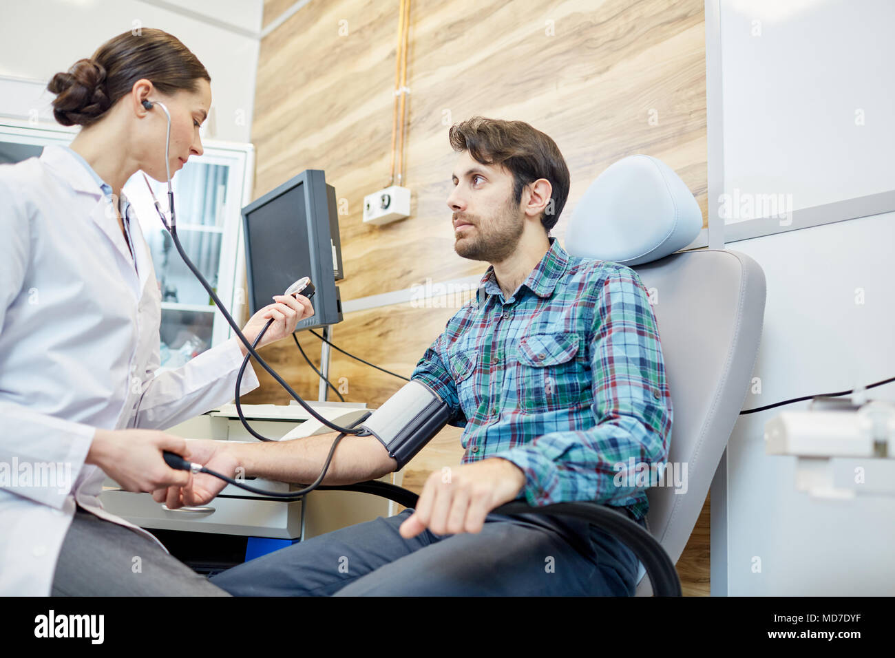 Female doctor checking blood pressure of the patient Stock Photo - Alamy