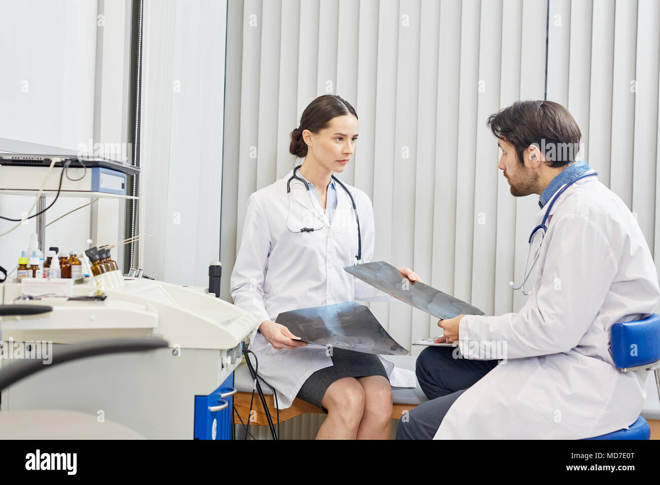 Two doctors examining young woman hi-res stock photography and images ...