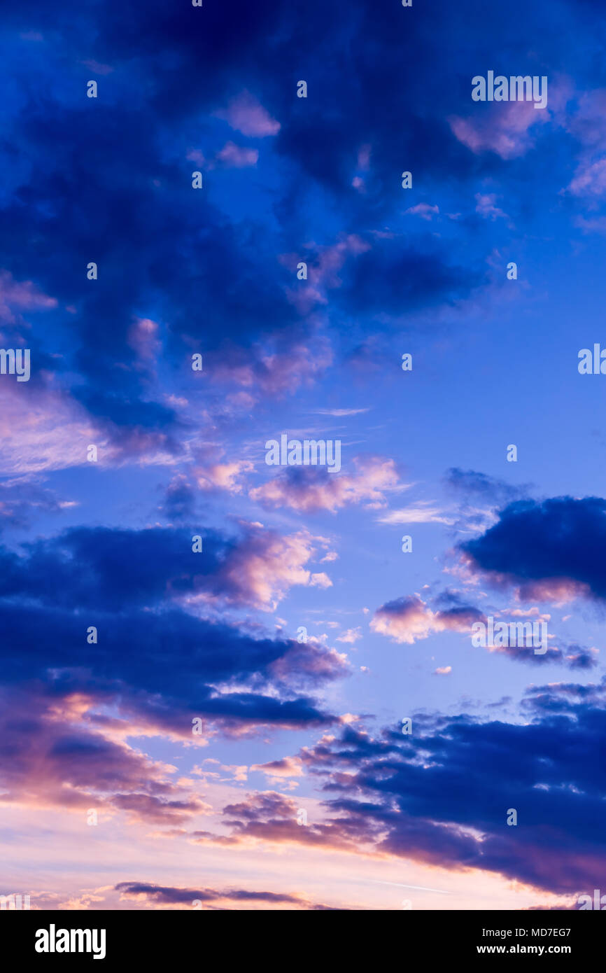Vivid color clouds on sunset landscape. Blue sky with bright pink ...