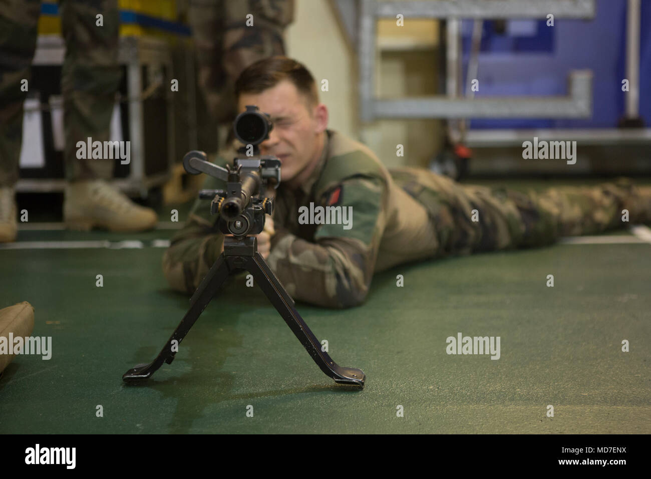 A French Marine sights through a rifle combat optic mounted to a M240B ...