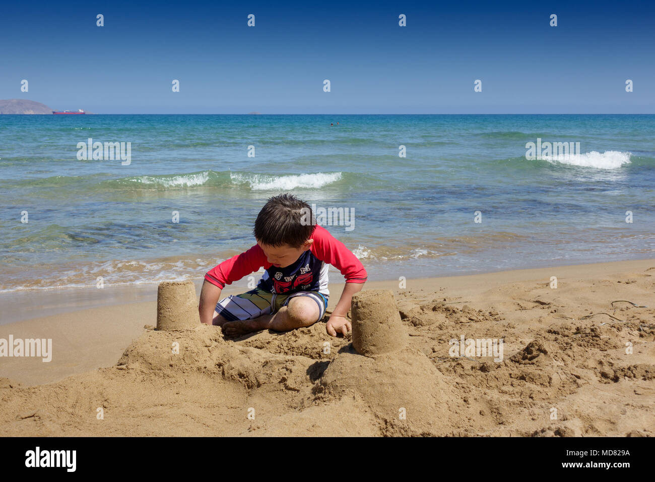 Boy building sandcastle on beach hi-res stock photography and images ...