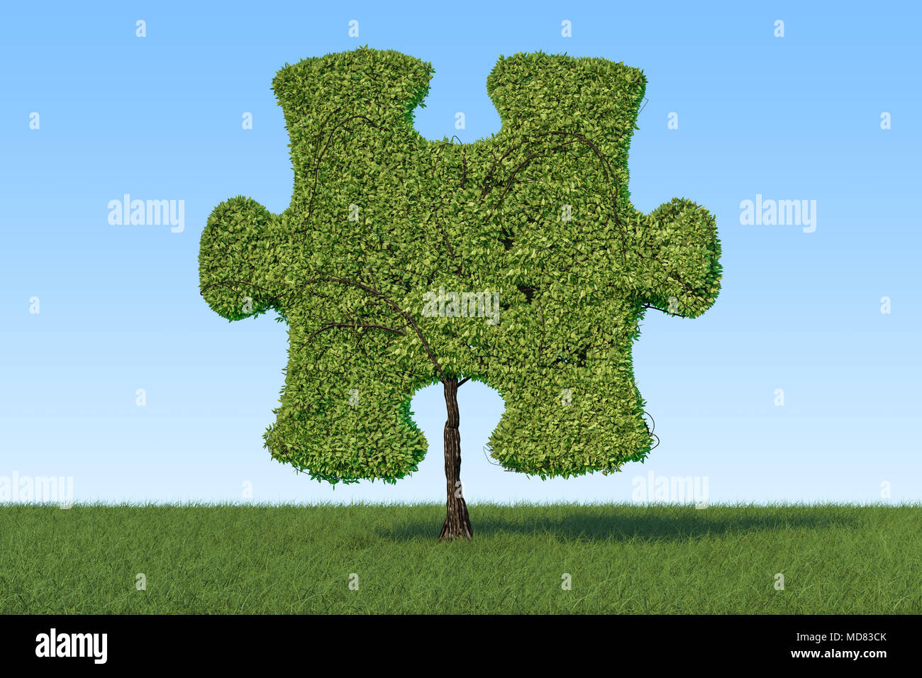 Green tree in the shape of puzzle on the green grass against blue sky ...