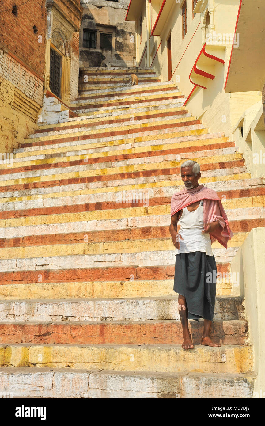 Man descends the steep stairs ascend to Sheetla Ghats in Varanasi Stock ...