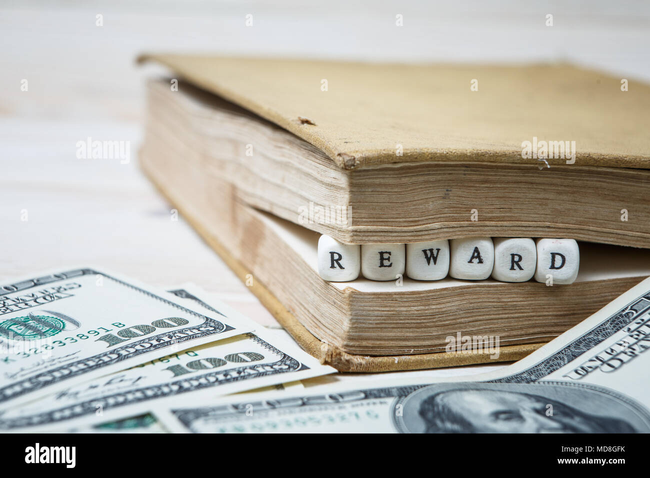 Word reward written in wooden blocks in book Stock Photo - Alamy