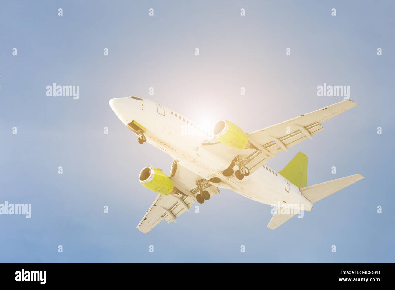 Big passenger airlplane flying against blue sky with bright sun ...