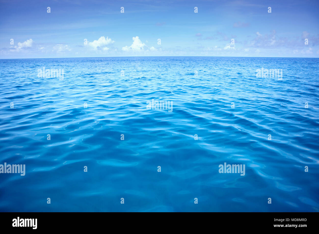 deep blue sea water with white cloud over sky Stock Photo - Alamy