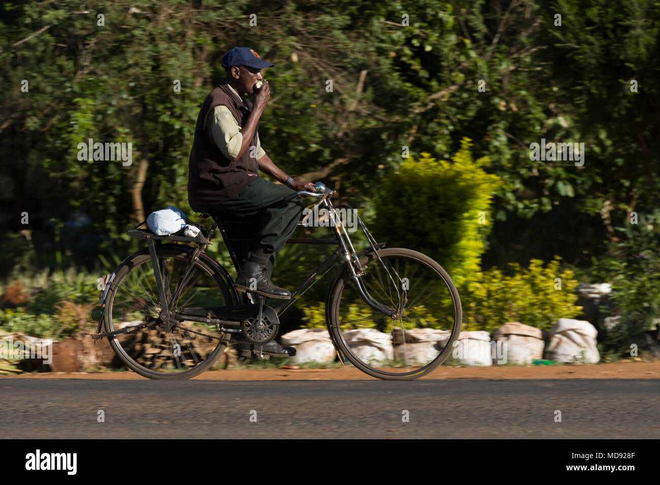 A cyclist rides a traditional roadster-style bicycle, commonly called a ...