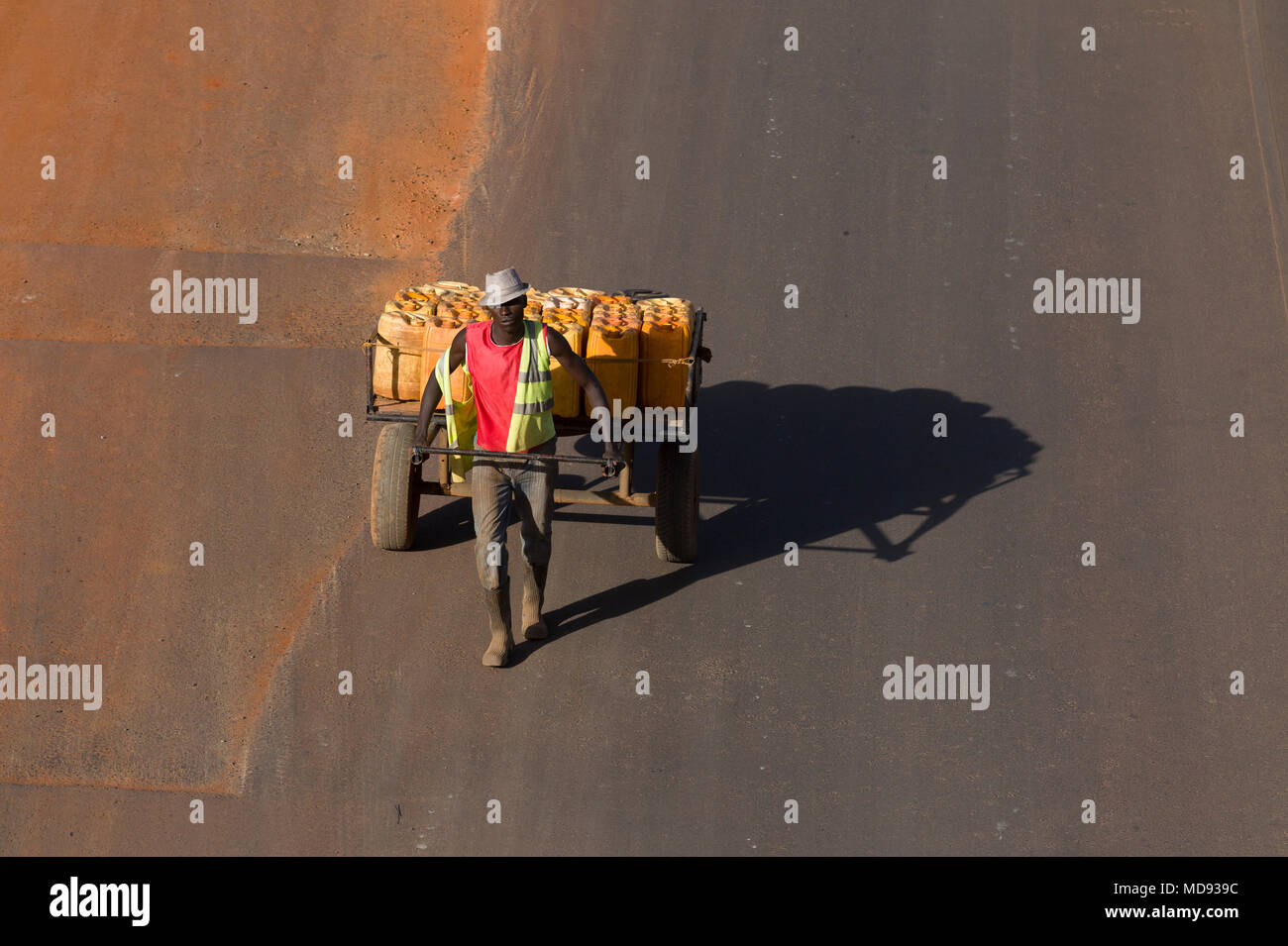 Delivery man pulling cart loaded hi-res stock photography and images ...