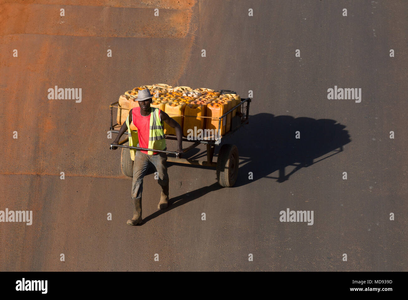 Delivery man pulling cart loaded hi-res stock photography and images ...
