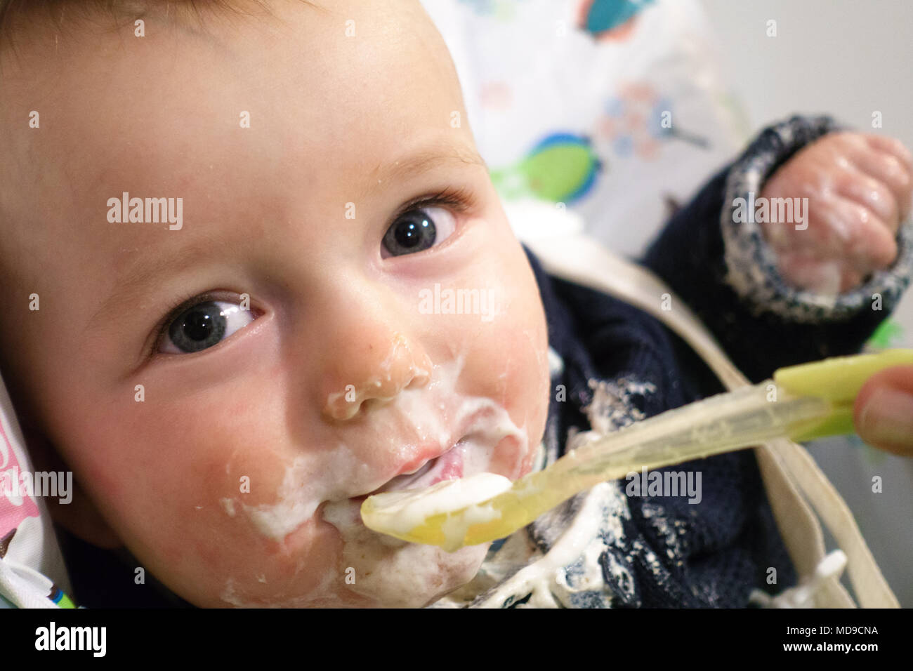 Portrait of little messy baby boy eating food Stock Photo - Alamy