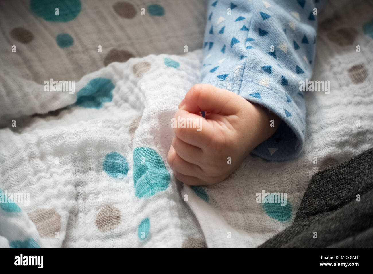Cute newborn baby hand on bed Stock Photo - Alamy