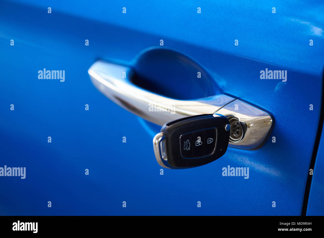 Black car key in blue car door close up view Stock Photo - Alamy