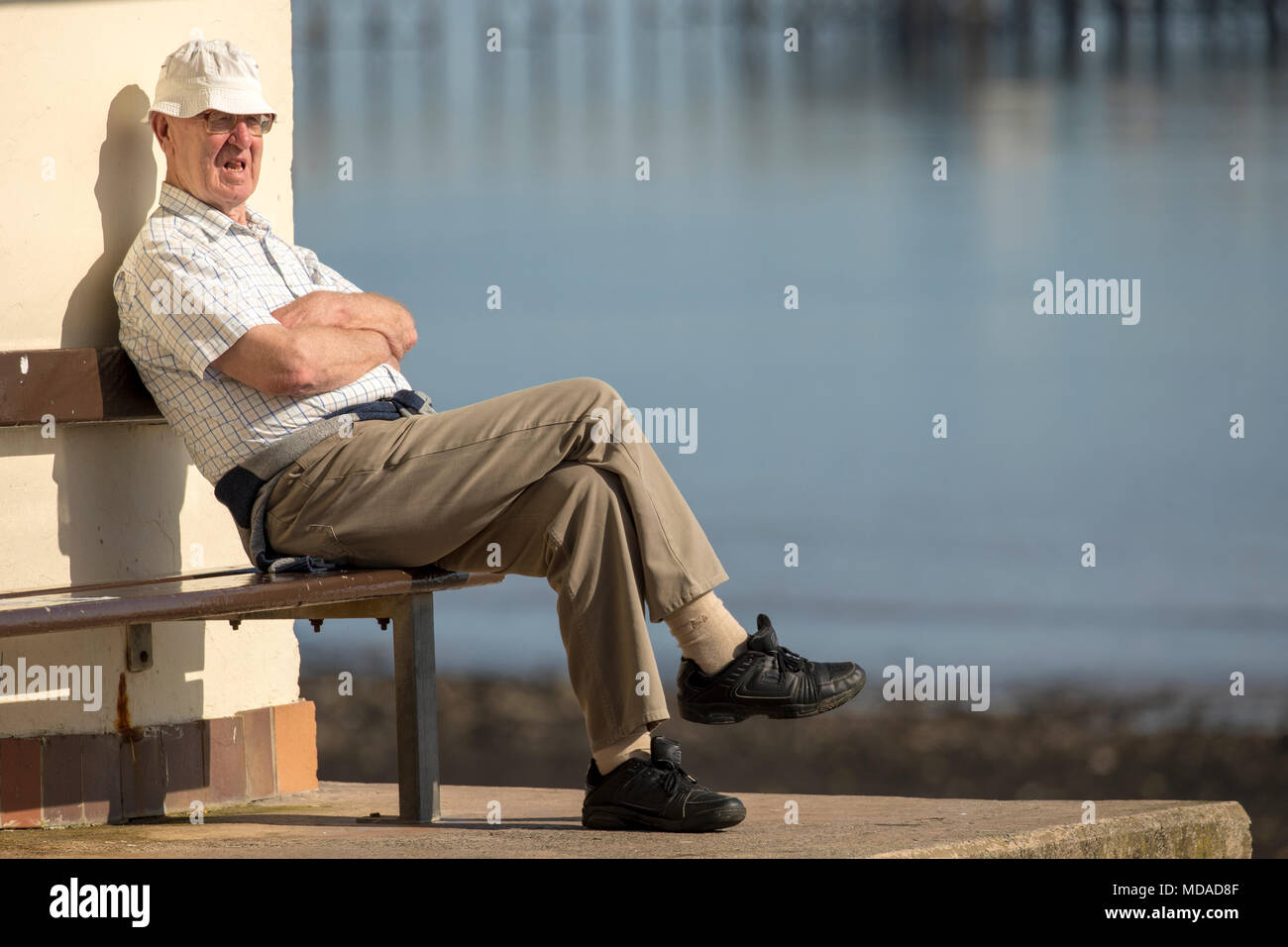 Elderly male alone sat on bench Stock Photo - Alamy