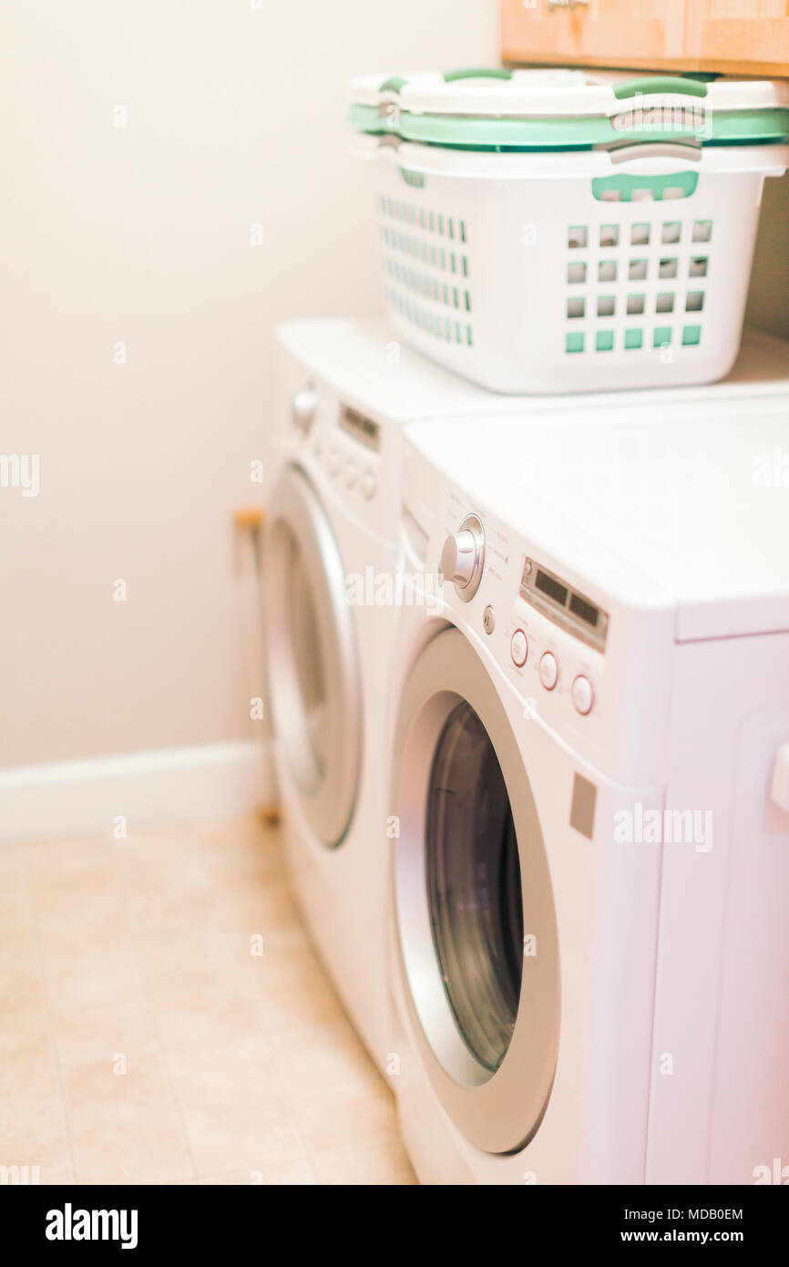 Doing laundry in laundry room of modern single family house in suburbs ...