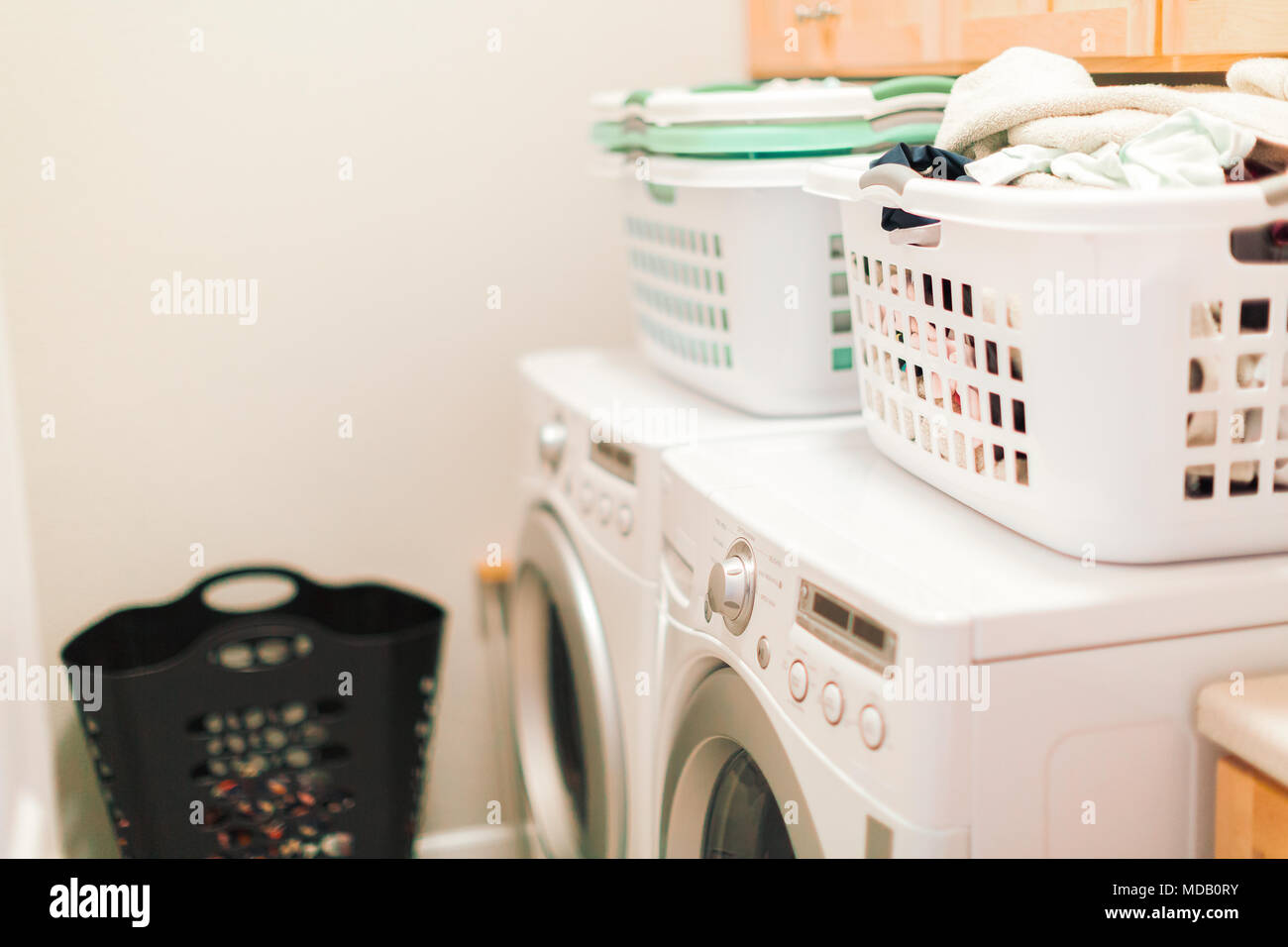 Doing laundry in laundry room of modern single family house in suburbs ...