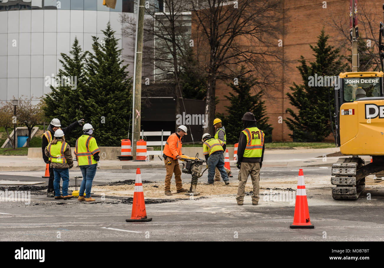 Baltimore, Maryland, USA. Construction workers labor with jackhammer on ...