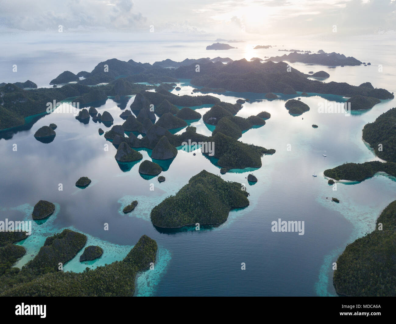 Beautiful limestone islands are fringed by coral reefs in Wayag, Raja ...