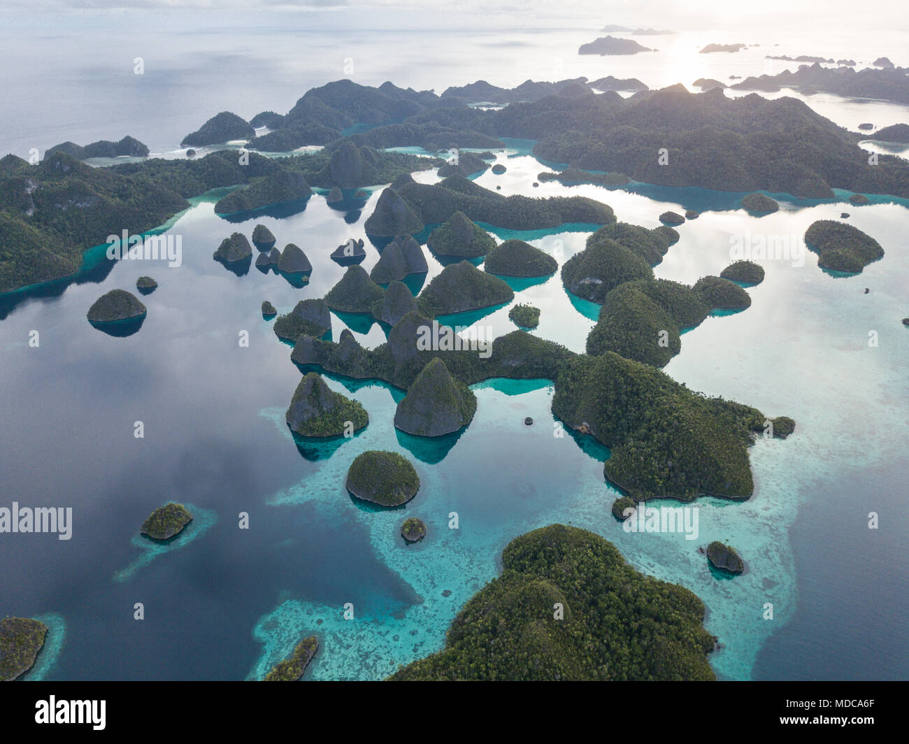 Beautiful limestone islands are fringed by coral reefs in Wayag, Raja ...