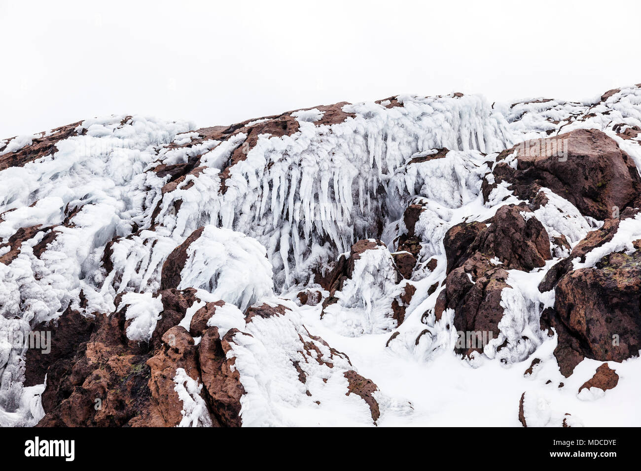 ice stalactites on volcanic rocks, Cayambe volcano, Ecuador Stock Photo ...