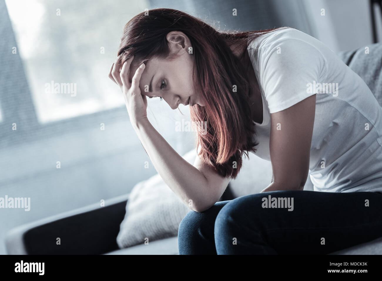 Upset dull woman having no energy Stock Photo - Alamy