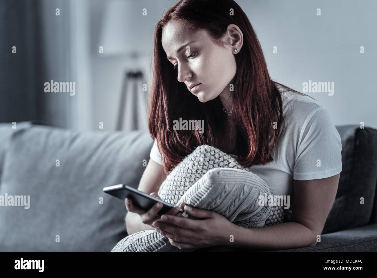 Upset charming woman waiting for message Stock Photo - Alamy