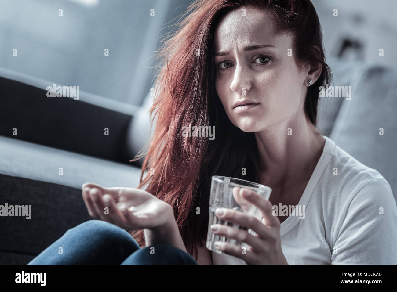 Dismal beautiful woman taking drugs Stock Photo - Alamy
